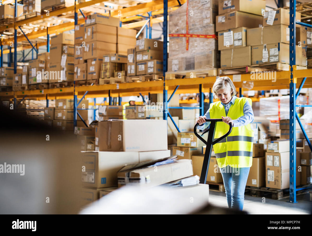 Warehouse pulling pallet truck boxes hi-res stock photography and ...