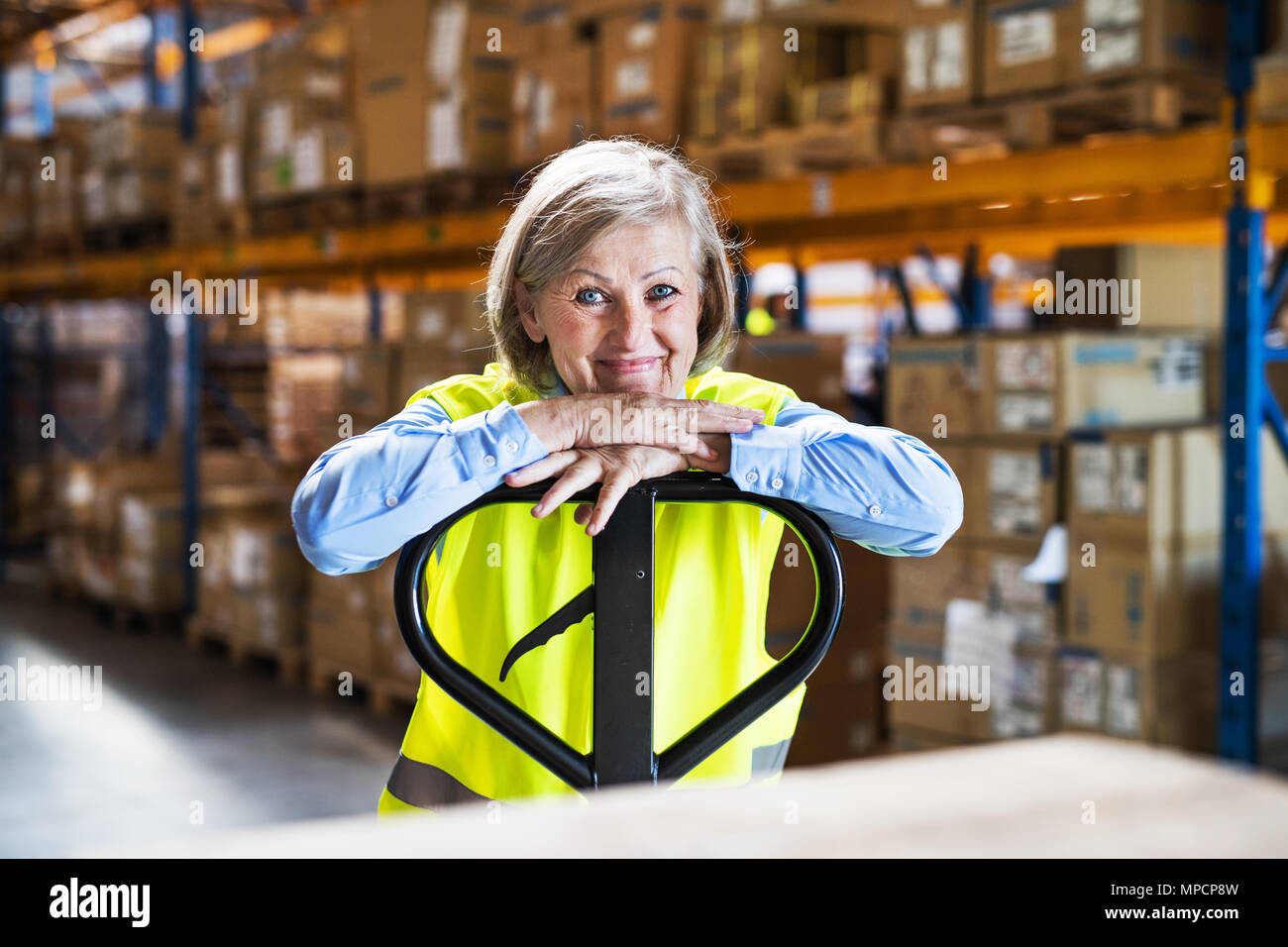 Senior woman worker or supervisor in a warehouse Stock Photo - Alamy