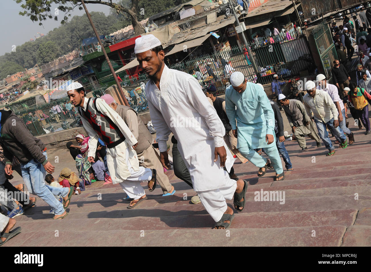India, New Delhi, Muslim men walking up the steps to the Jama Masjid ...