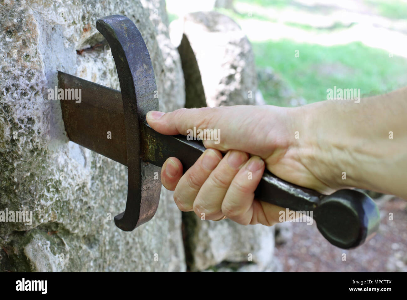 hand of knight that attempts to remove the magical sword Excalibur from ...