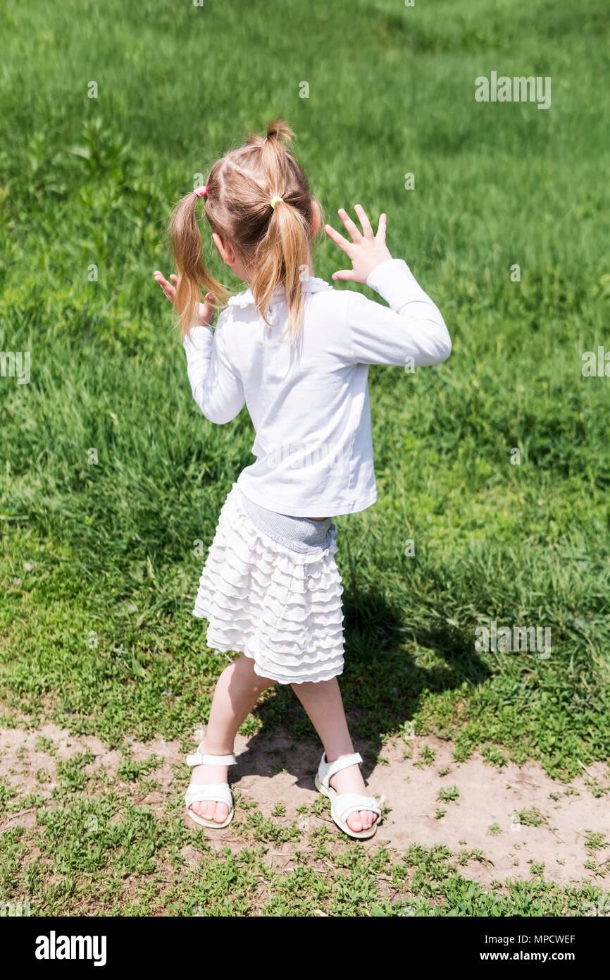 Little girl turned her back on the camera to the shadows Stock Photo ...