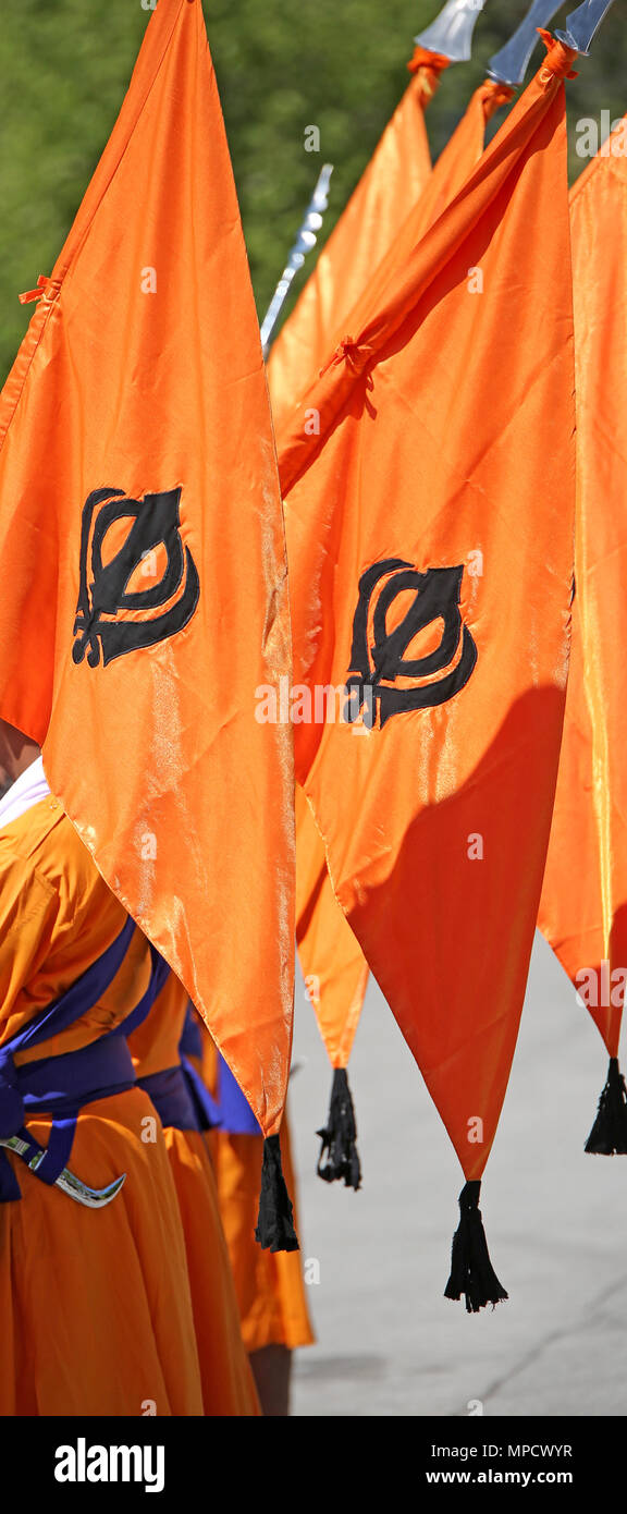 big orange flag with symbol of Sikh called Khanda during a religious ...