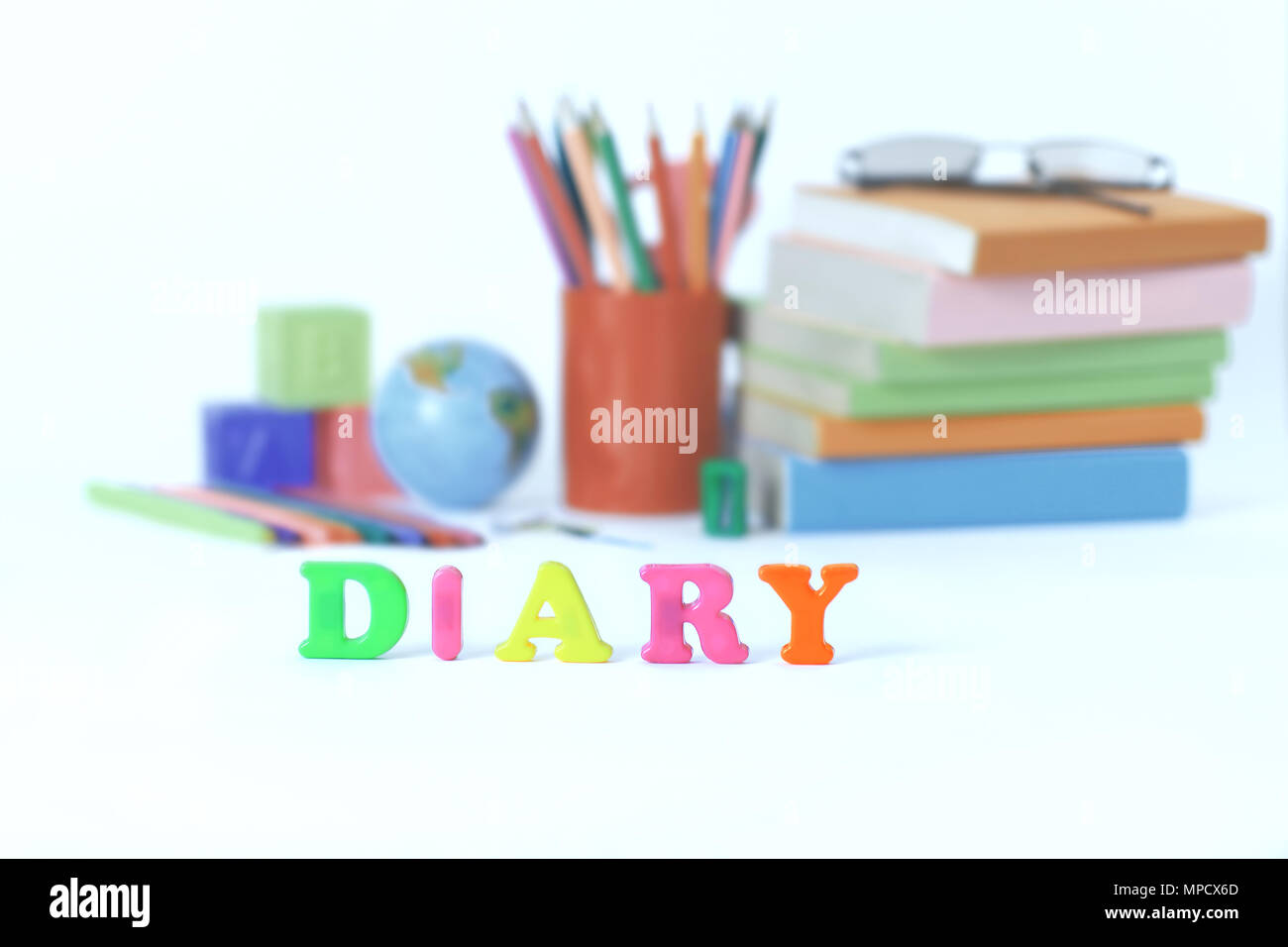 word diary on blurred background of school supplies .photo with copy ...