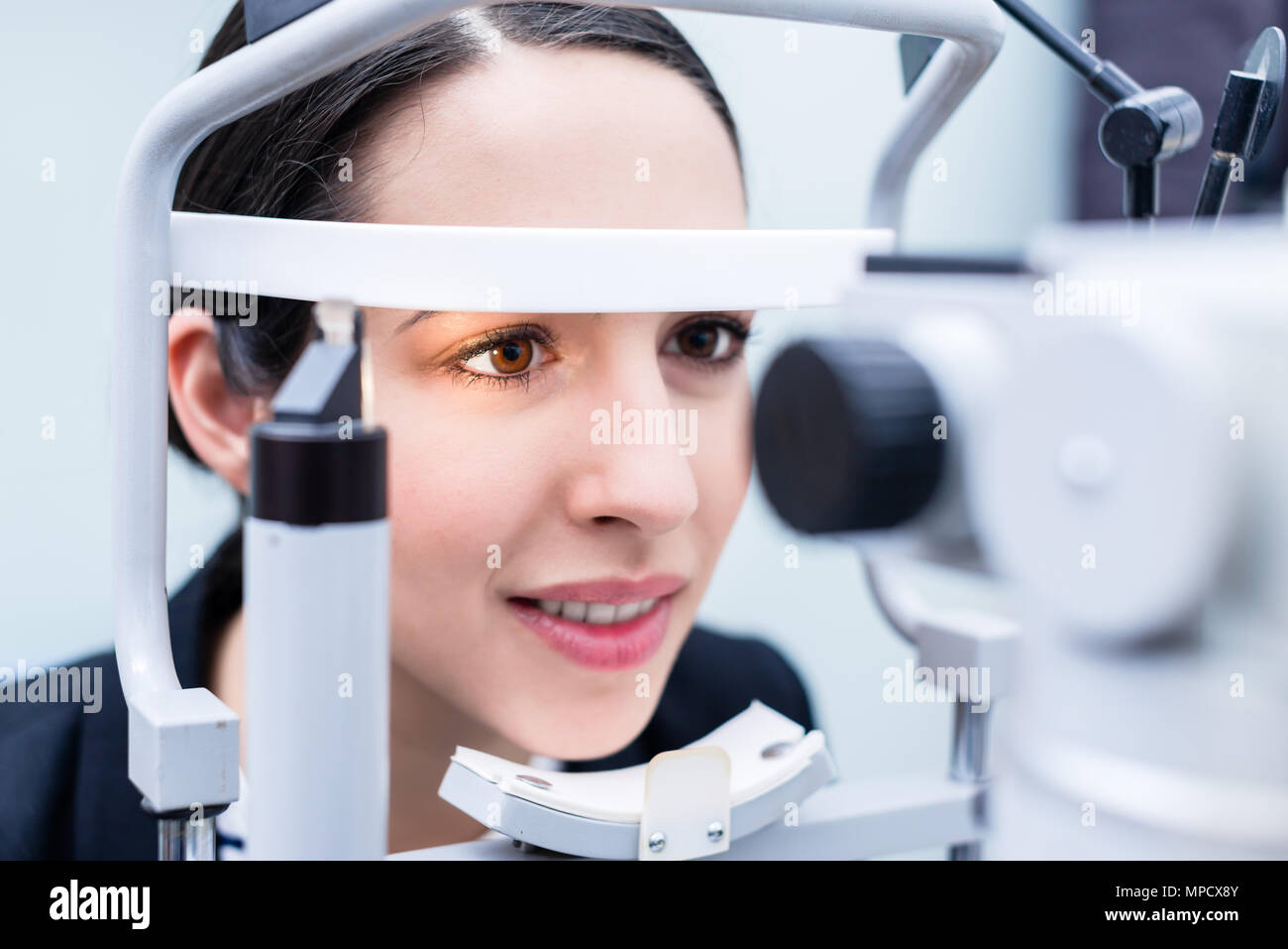 Woman having eyes measured with test device Stock Photo - Alamy