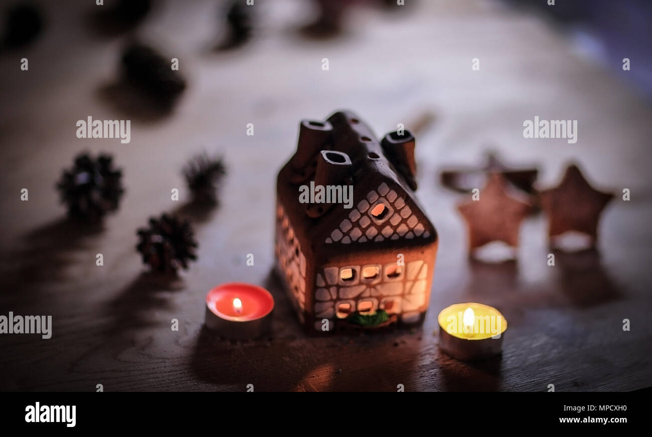 gingerbread house candle on blurred background of the table Stock Photo ...