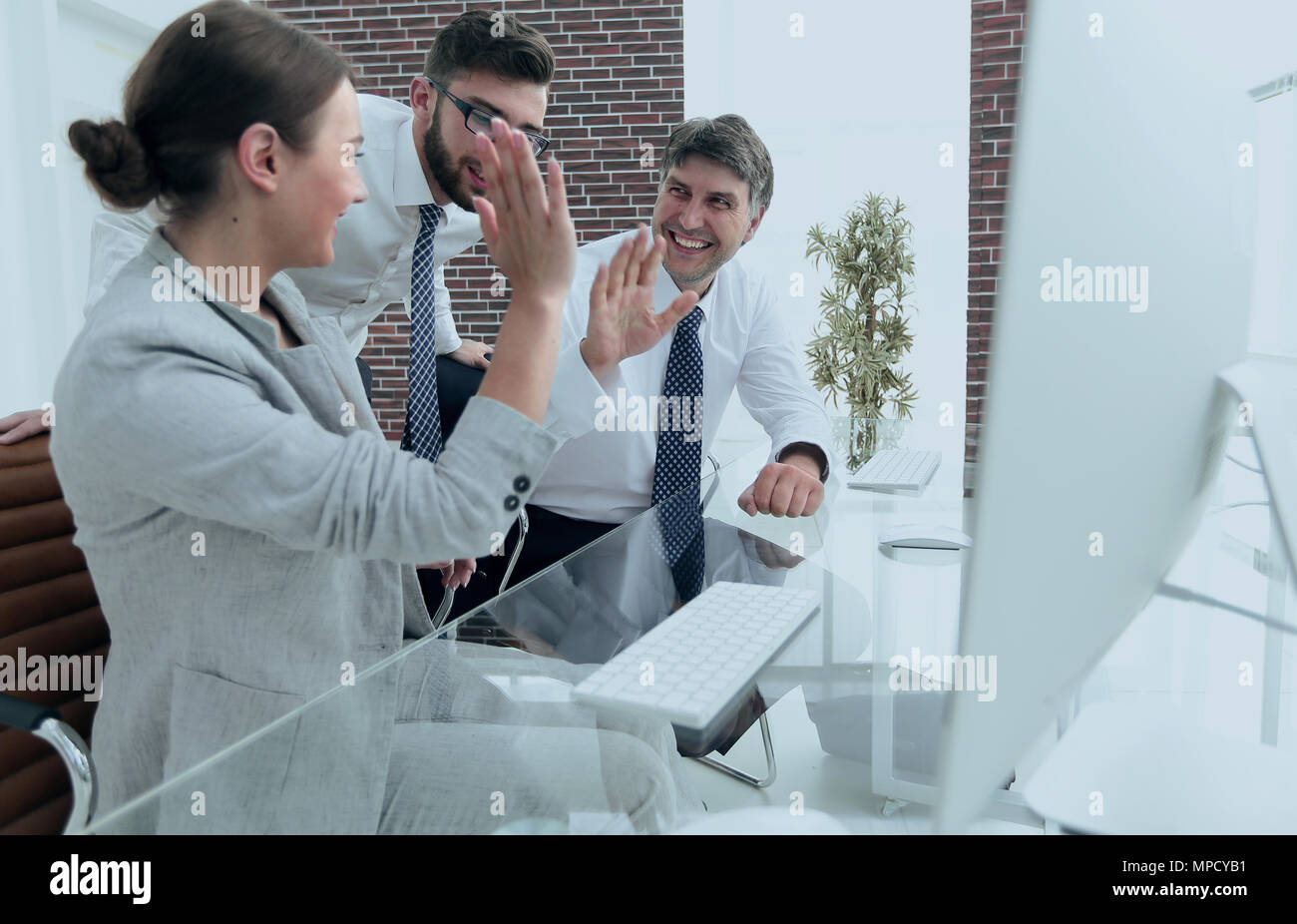 Friendly business team shows its success Stock Photo - Alamy