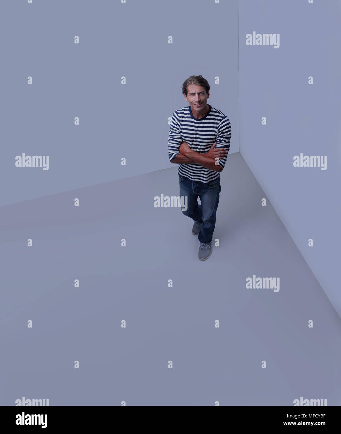 modern man standing in the corner of the white room Stock Photo - Alamy