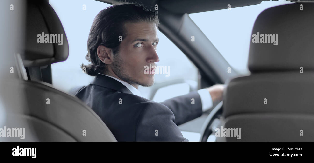 man sitting behind the wheel of a car Stock Photo - Alamy