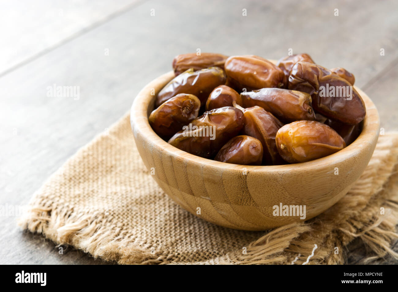 dates food in wooden bowl on wooden table Stock Photo - Alamy