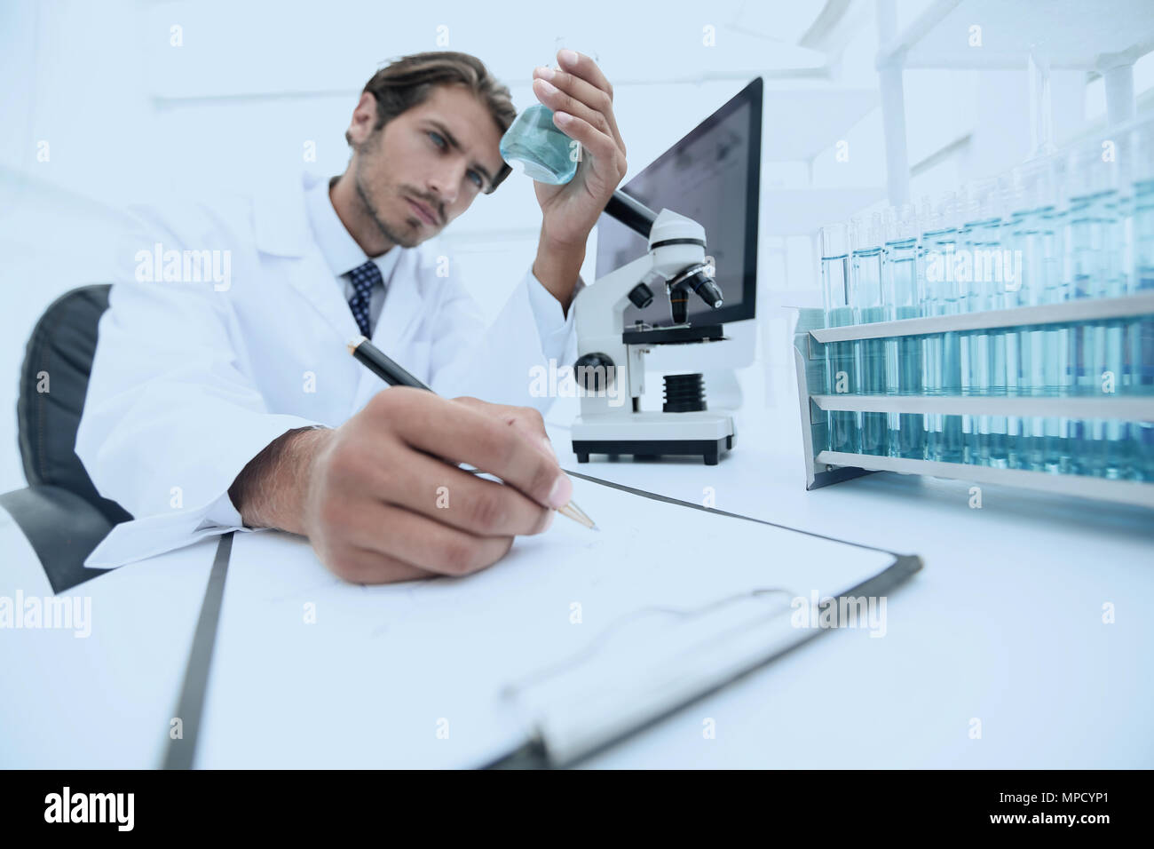 scientist analyzing an experiment in a laboratory Stock Photo - Alamy