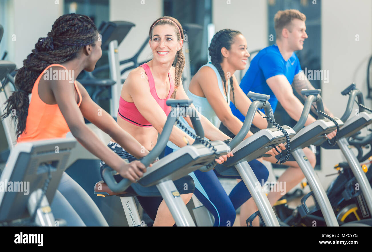 Side view of a beautiful woman smiling while cycling at the gym Stock ...