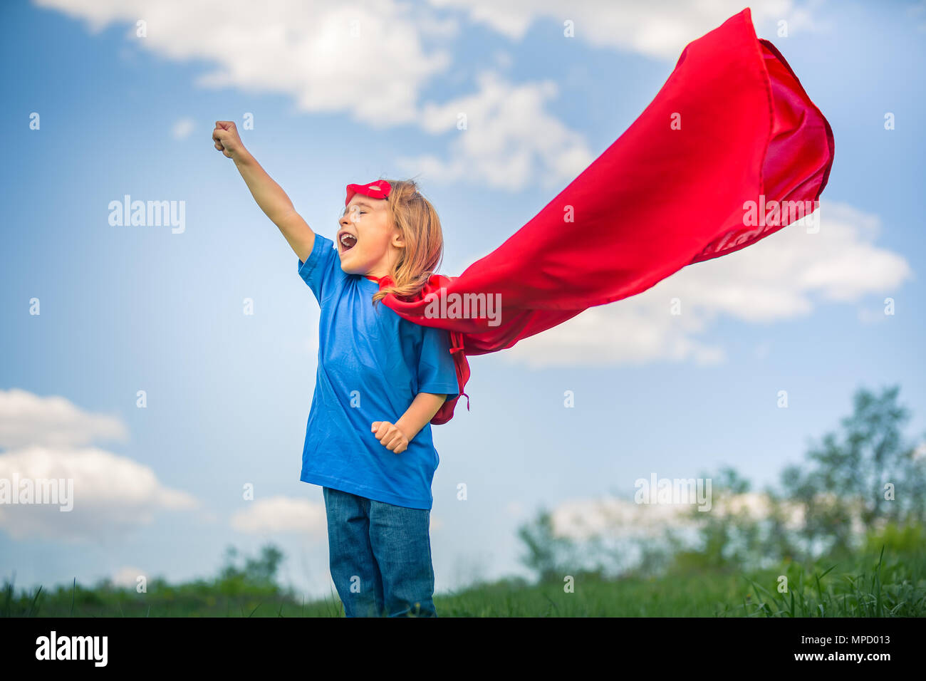 Funny little girl playing power super hero Stock Photo - Alamy