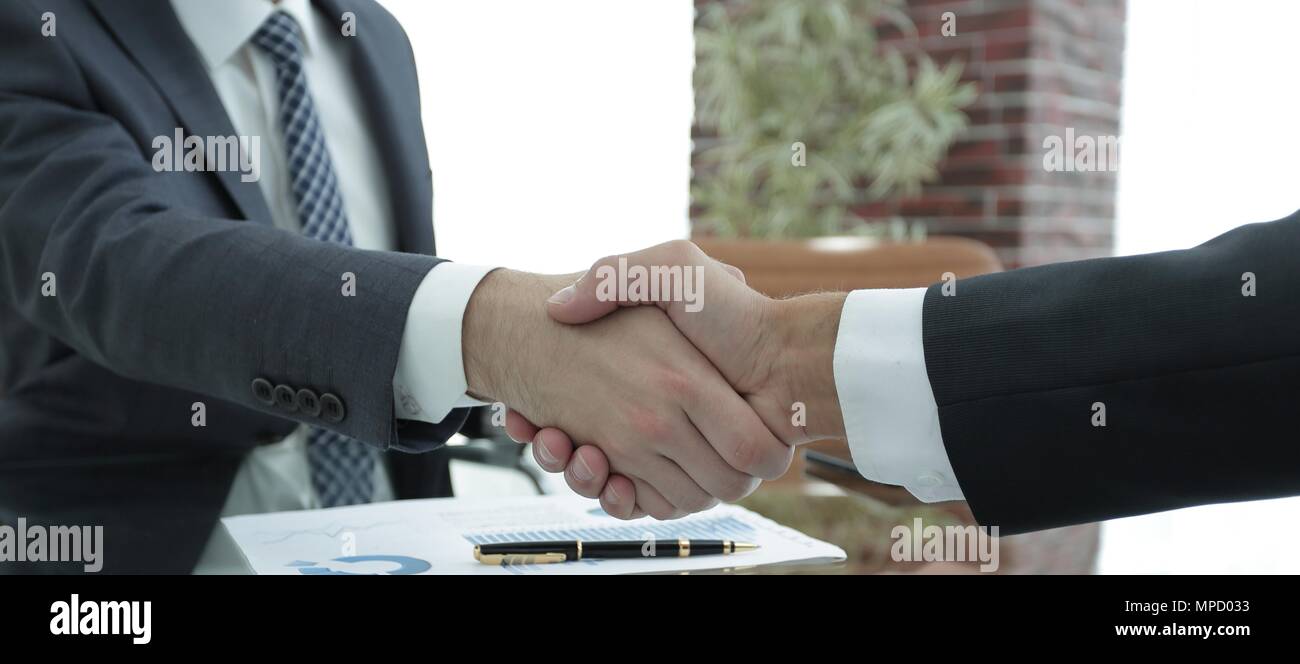 financial partners handshake after signing contract Stock Photo - Alamy