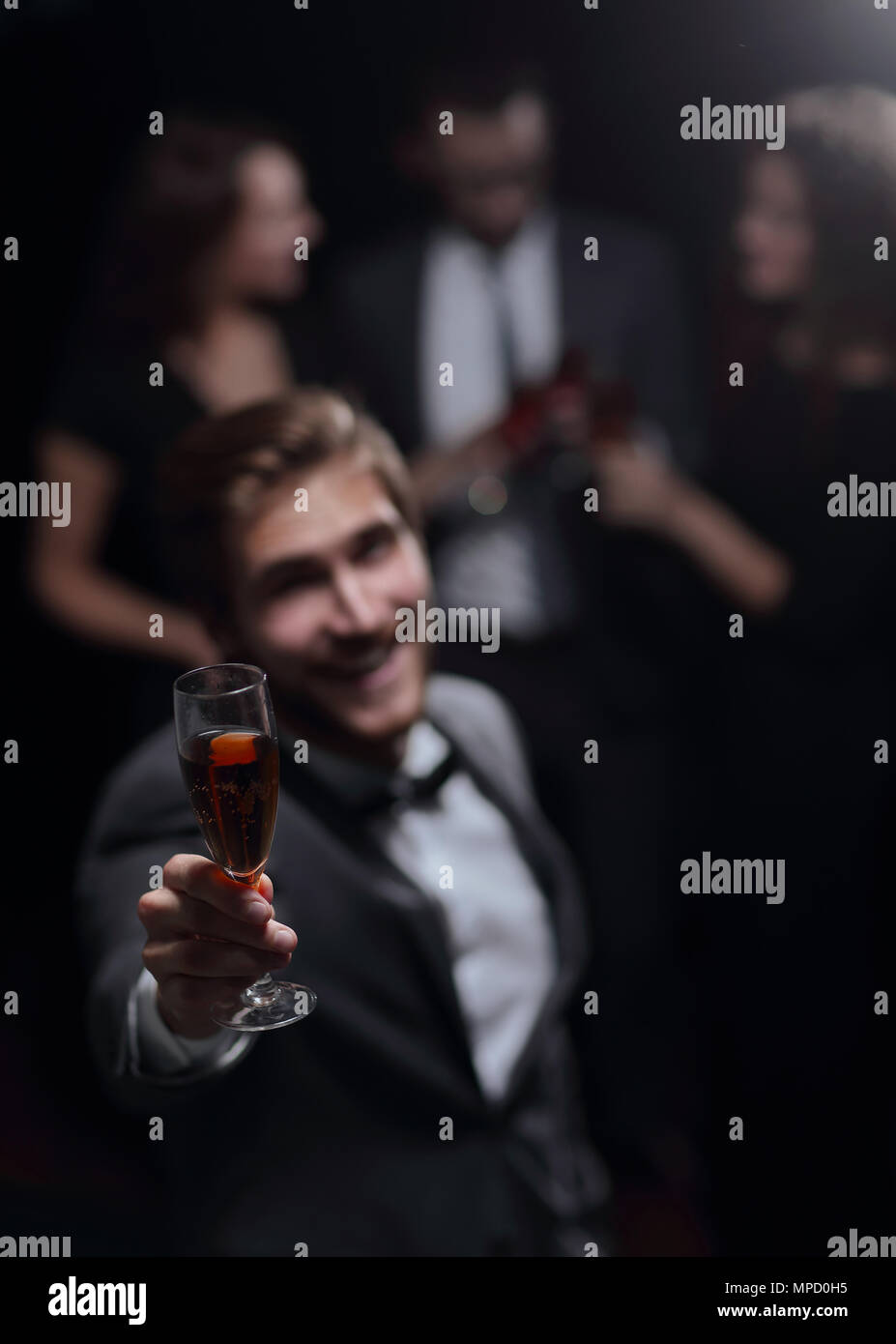 stylish young man raising his glass in a toast Stock Photo - Alamy