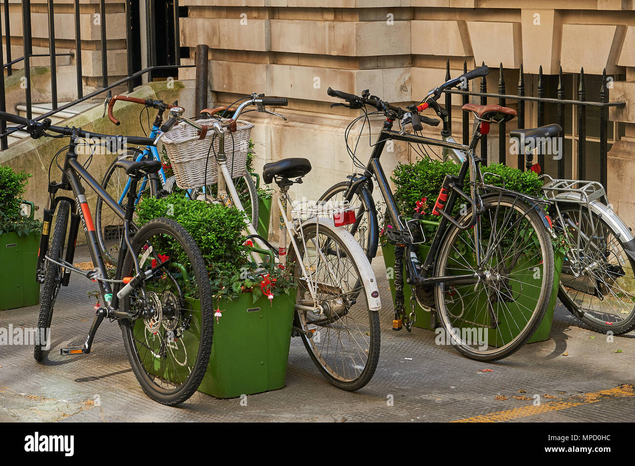 Bicycles parked outside an office using "Plantlock" planter system ...