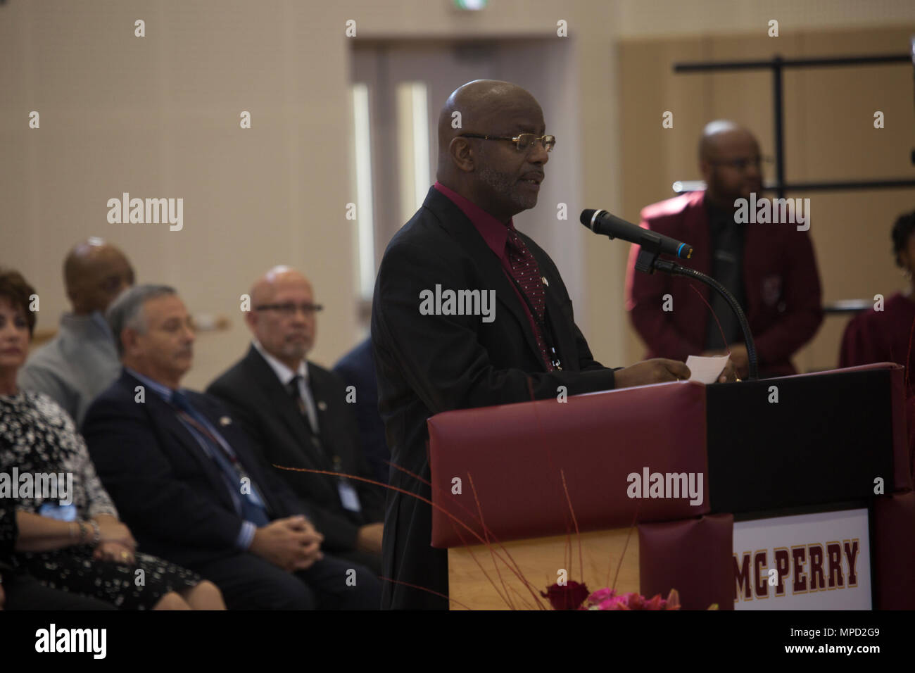 Principal Lorenzo Brown addresses the audience at the Matthew C. Perry ...