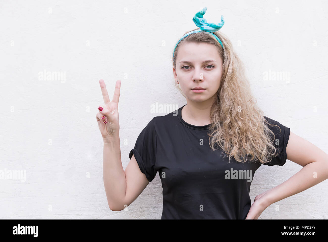girl shows two fingers up, sign, attention, countdown Stock Photo - Alamy