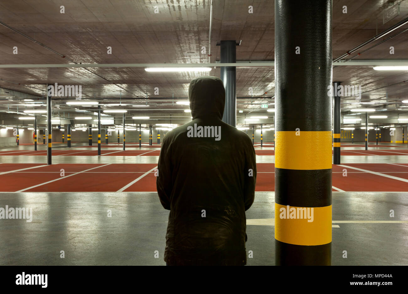 new underground parking, back view of shady man Stock Photo - Alamy