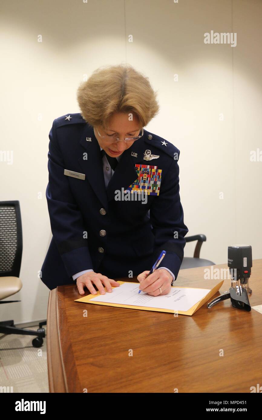 Brig. Gen. Carol Timmons signs her oath as the Adjutant General for the ...