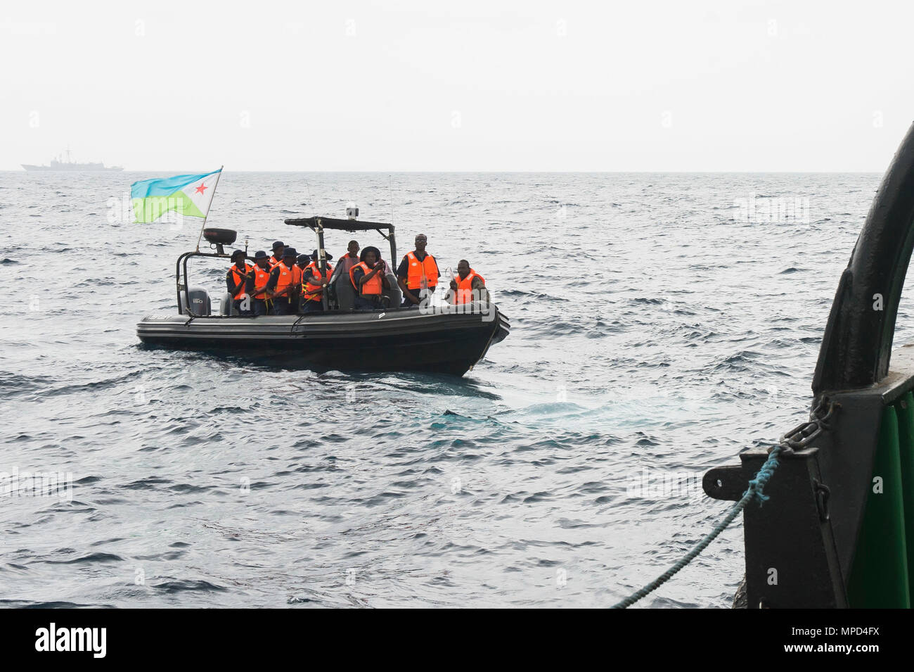 A Mozambique Marine boarding team approaches the Djibouti Coast Guard ...