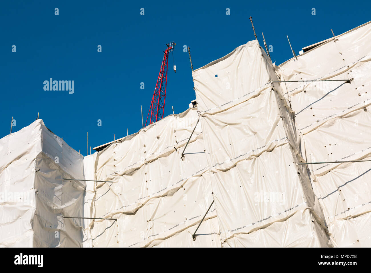 Building under construction with protective wrapping UK Stock Photo - Alamy