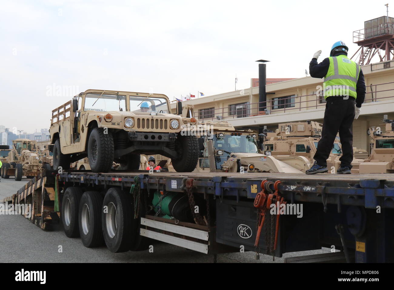 A Humvee is uploaded and tied down on a commercial ground asset at Pier ...