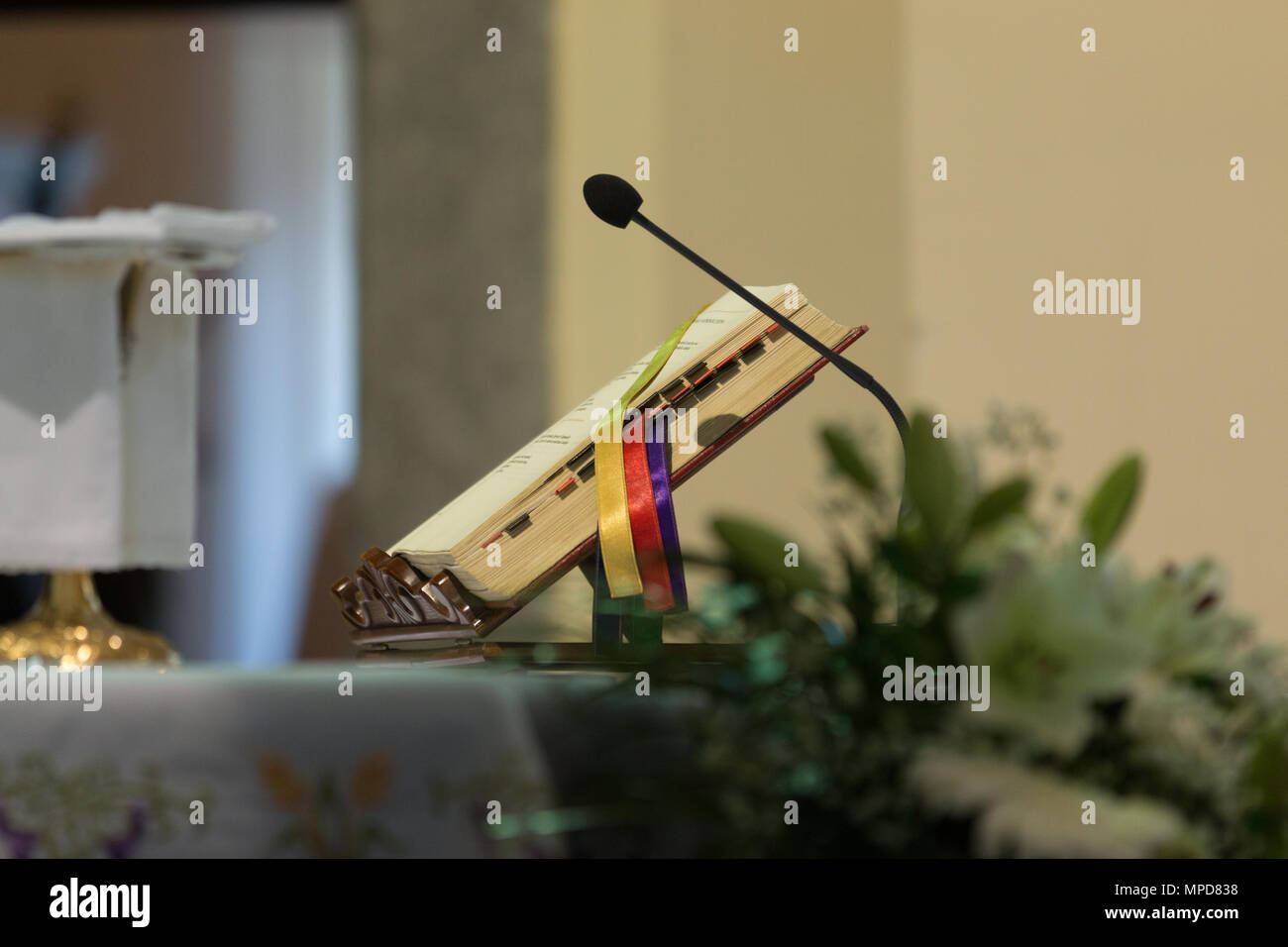Catholic sermon book on altar during mass Stock Photo - Alamy