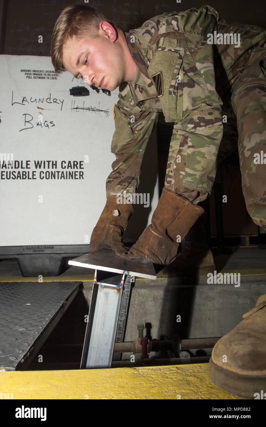 Spc. Brett Alkire, a machinist/welder with the 703rd Brigade Support ...