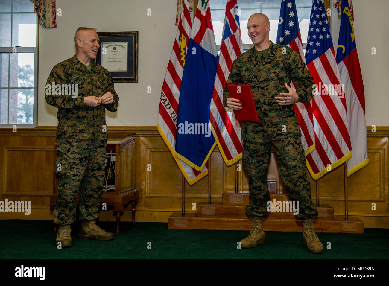 U.S. Marine Corps Cpl. Caulan A. Brooks, right, gives his remarks ...