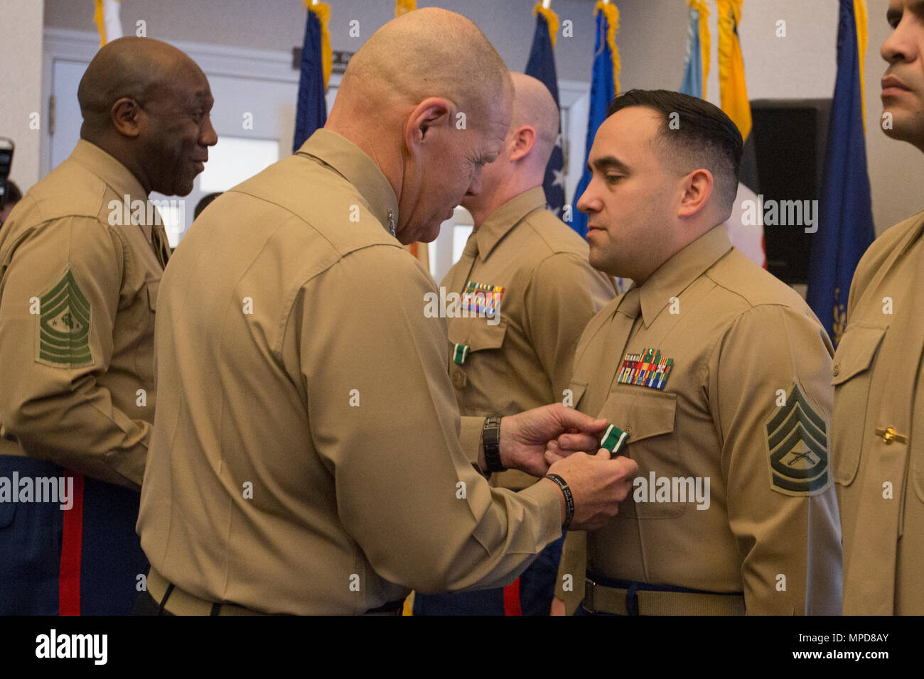 Commandant of the Marine Corps Gen. Robert B. Neller, left, pins a Navy ...