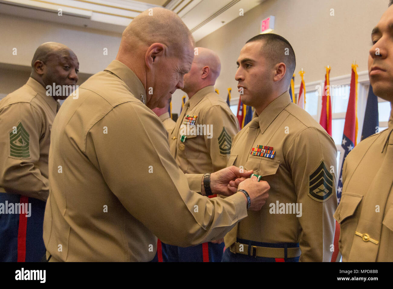 Commandant of the Marine Corps Gen. Robert B. Neller, left, pins a Navy ...