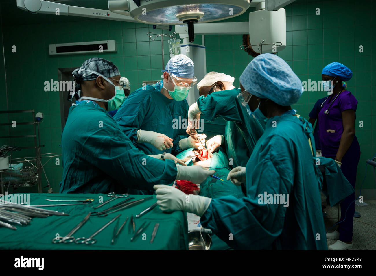 U.S. Army and Ghanaian medical professionals perform a radical ...