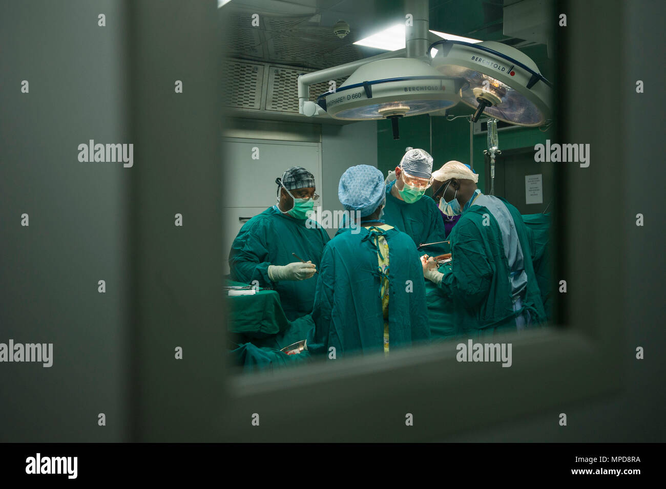 U.S. Army and Ghanaian medical professionals perform a radical ...