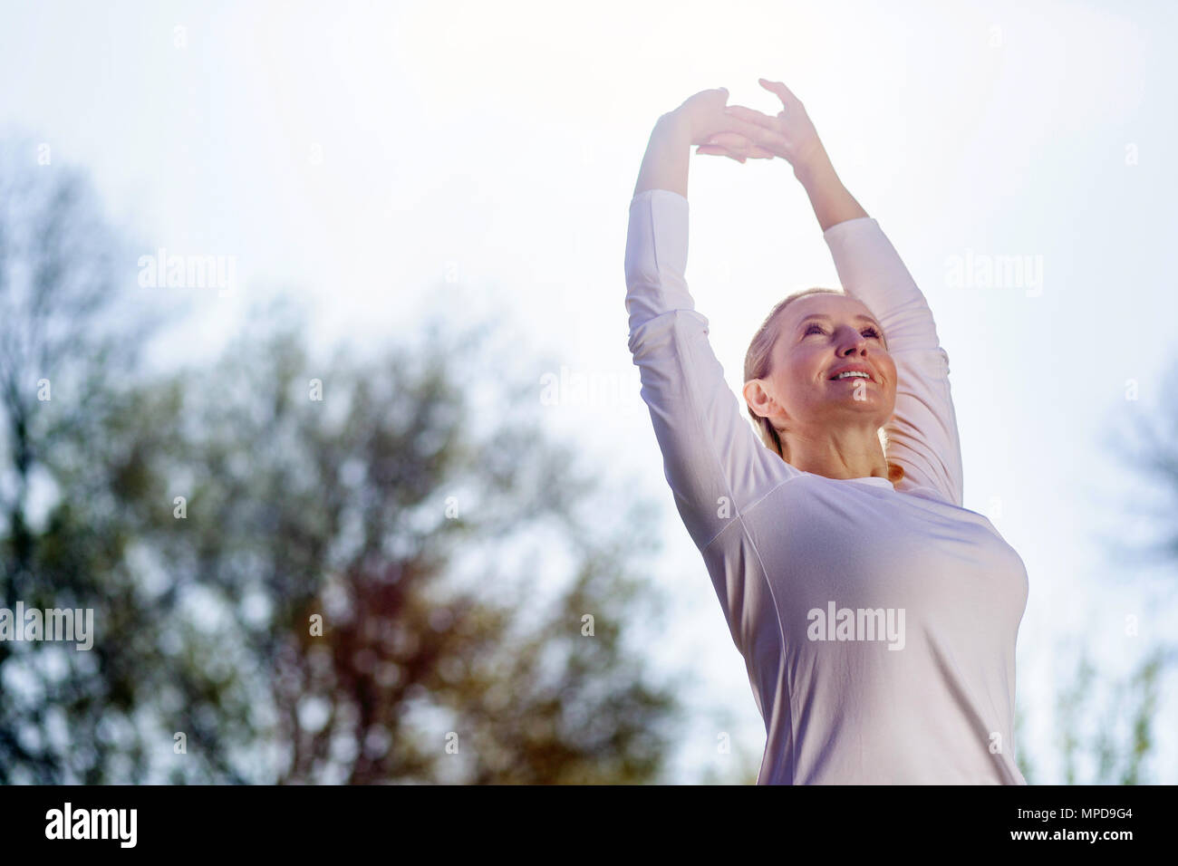 Nice cheerful woman holding her hands up Stock Photo - Alamy
