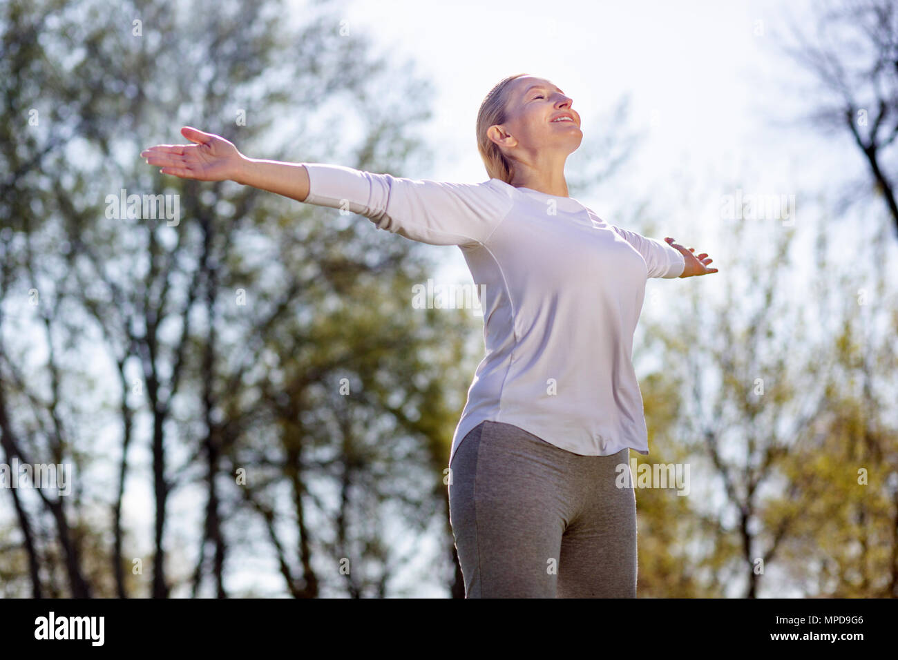 Happy peaceful woman breathing fresh air Stock Photo - Alamy