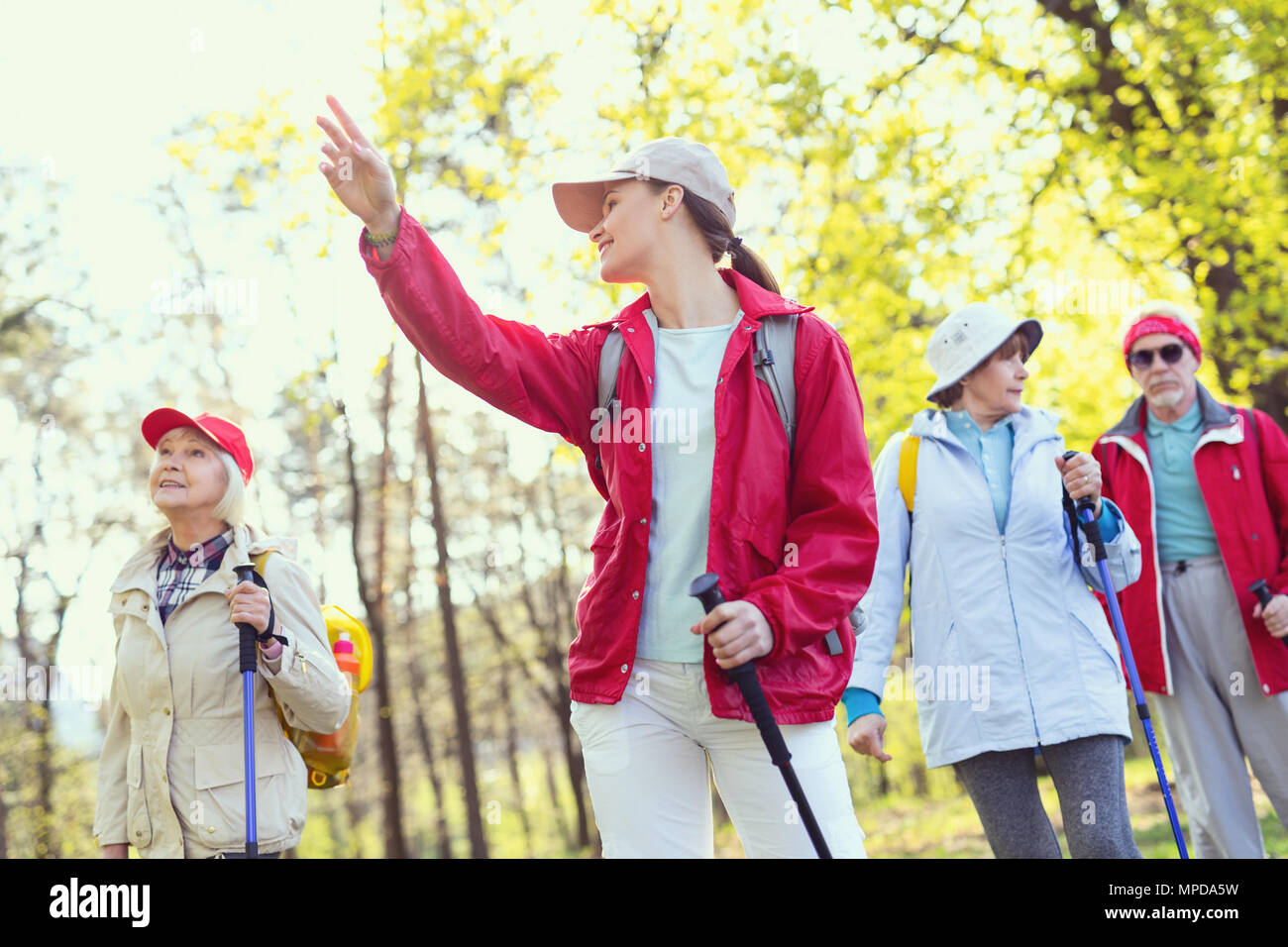 Cheerful guide showing the way Stock Photo - Alamy