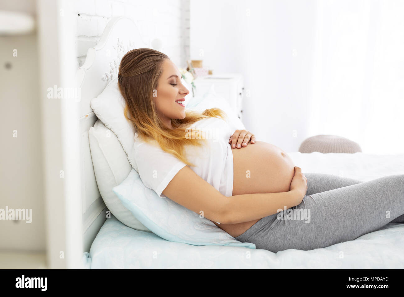 Joyful pregnant woman enjoying pregnancy Stock Photo - Alamy