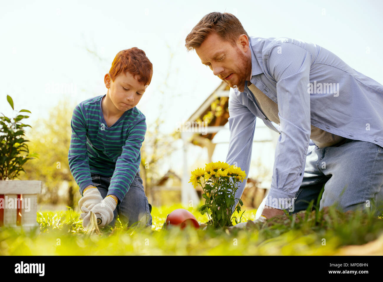 Hard working nice man sitting on the ground Stock Photo - Alamy