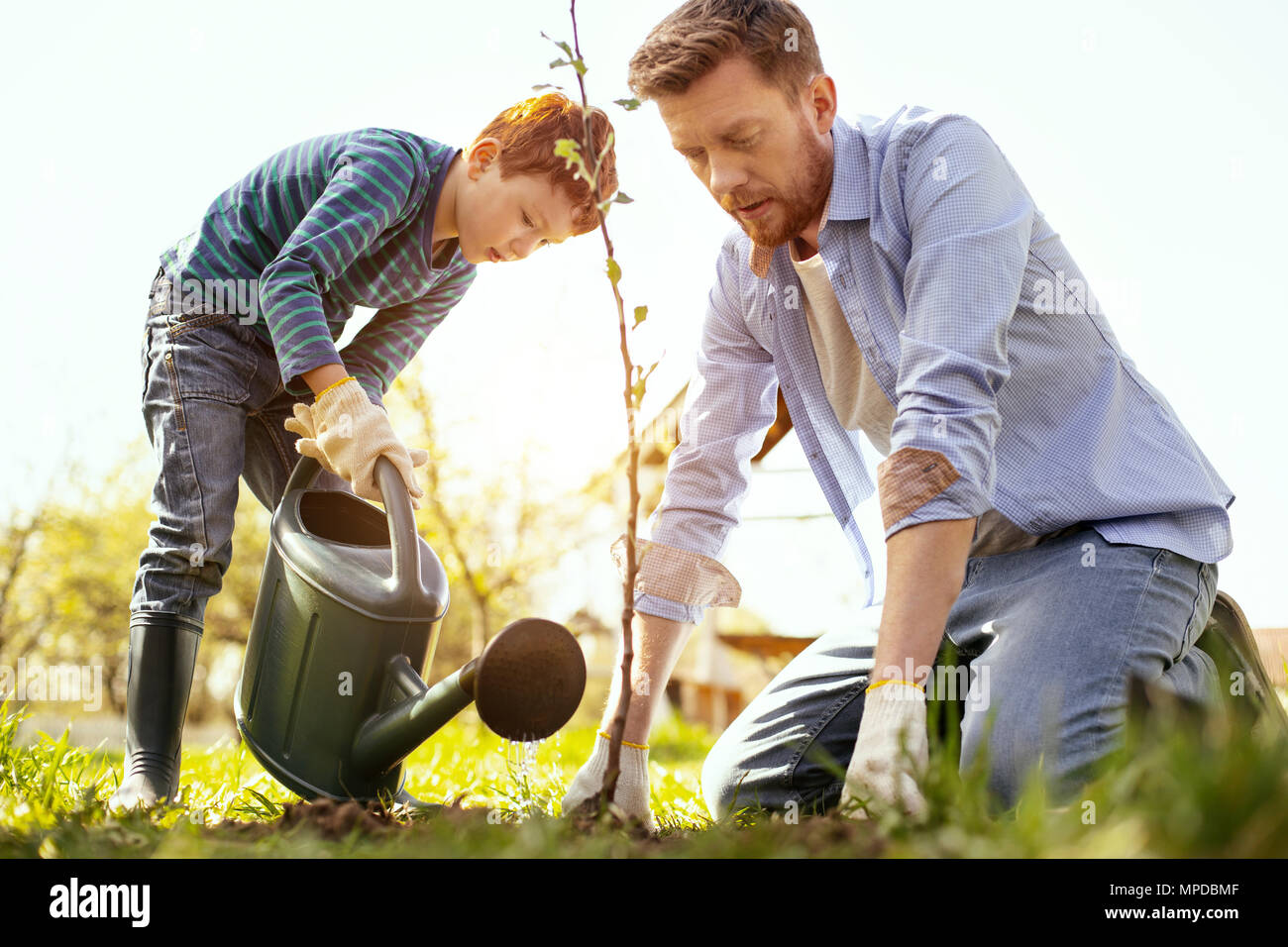 Nice serious man sitting on the ground Stock Photo - Alamy