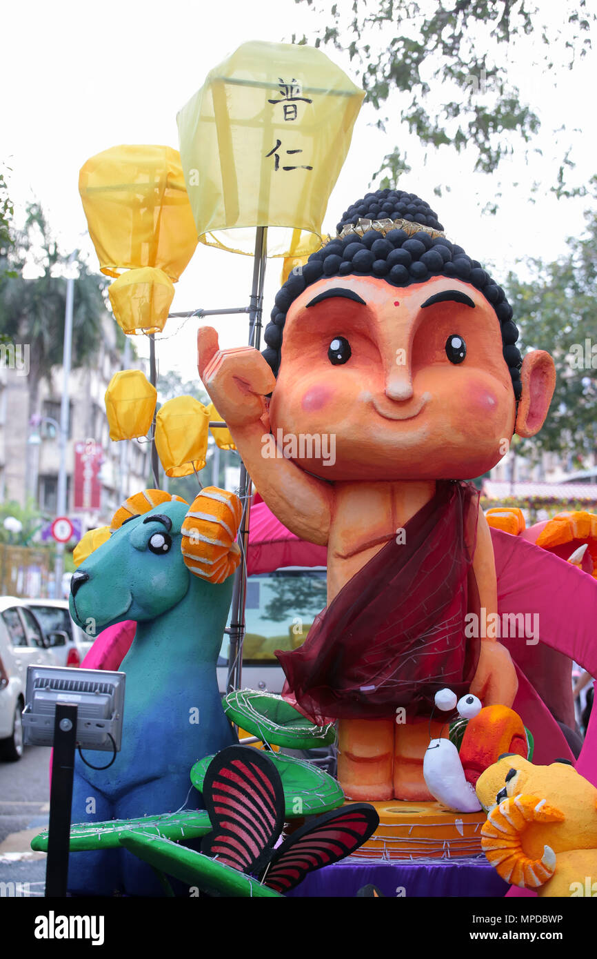 A carved out buddha styrofoam mounted on a buddhish procession vehicles ...