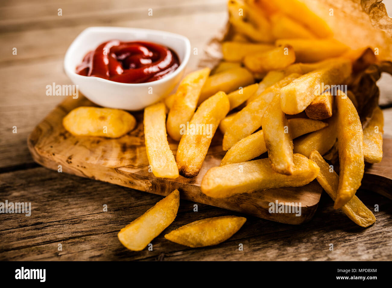 French fries on wooden table Stock Photo - Alamy