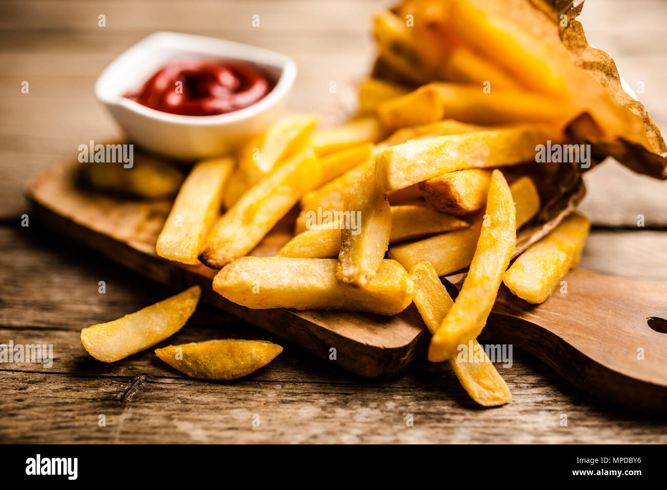 French fries on wooden table Stock Photo - Alamy
