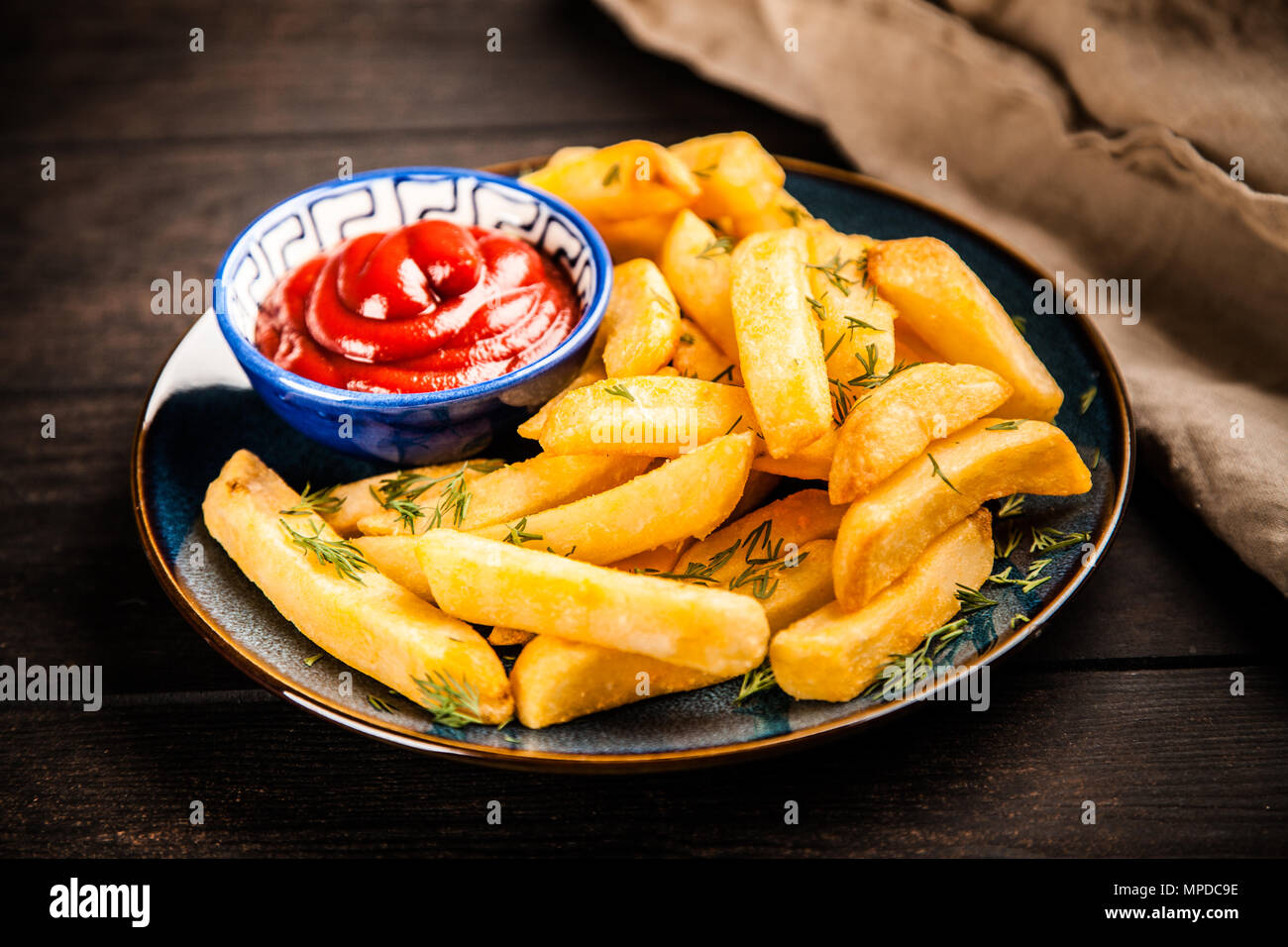 French fries on wooden table Stock Photo - Alamy