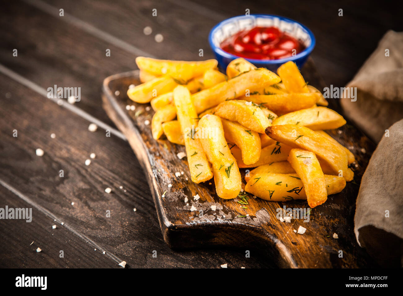 French fries on wooden table Stock Photo - Alamy