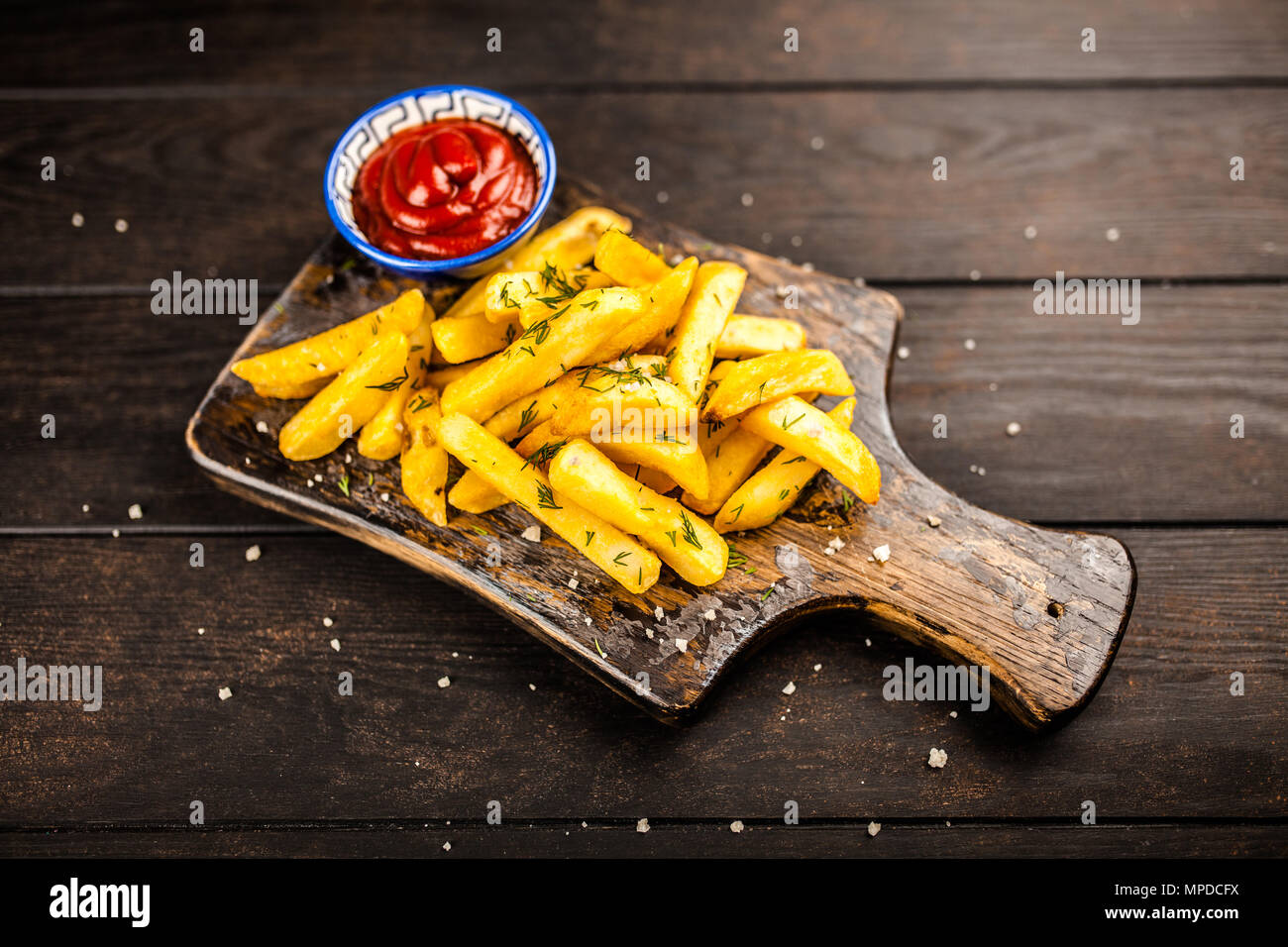 French fries on wooden table Stock Photo - Alamy