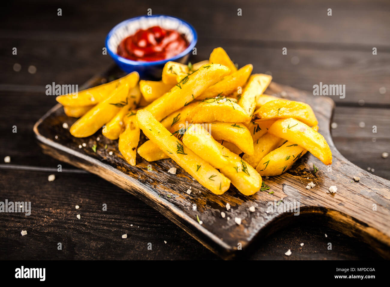 French fries on wooden table Stock Photo - Alamy