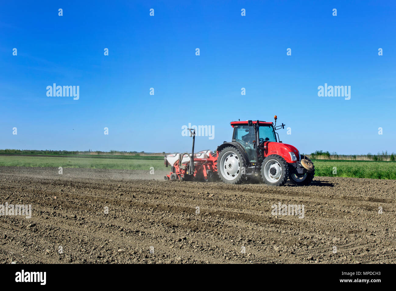 Tractor sows hi-res stock photography and images - Alamy