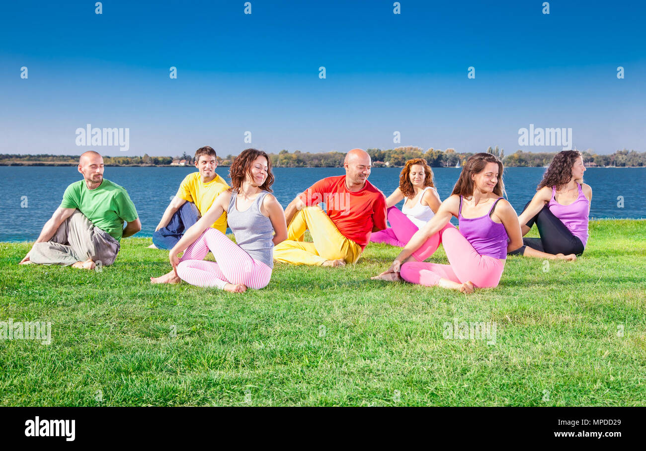 Young people practice Yoga asana on lakeside. Yoga concept Stock Photo ...