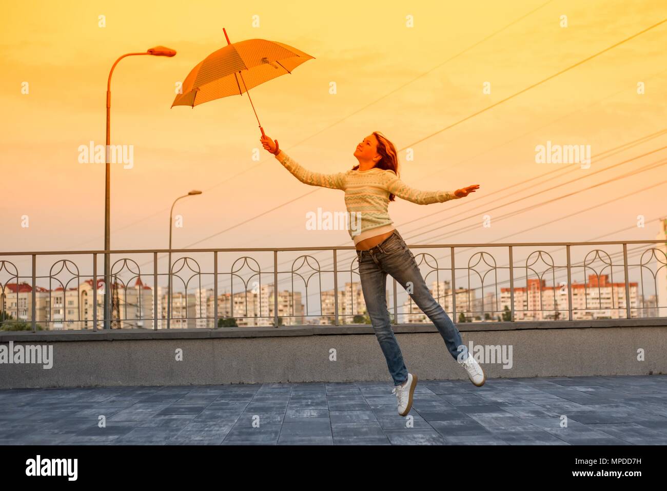 The girl is flying with an umbrella Stock Photo - Alamy