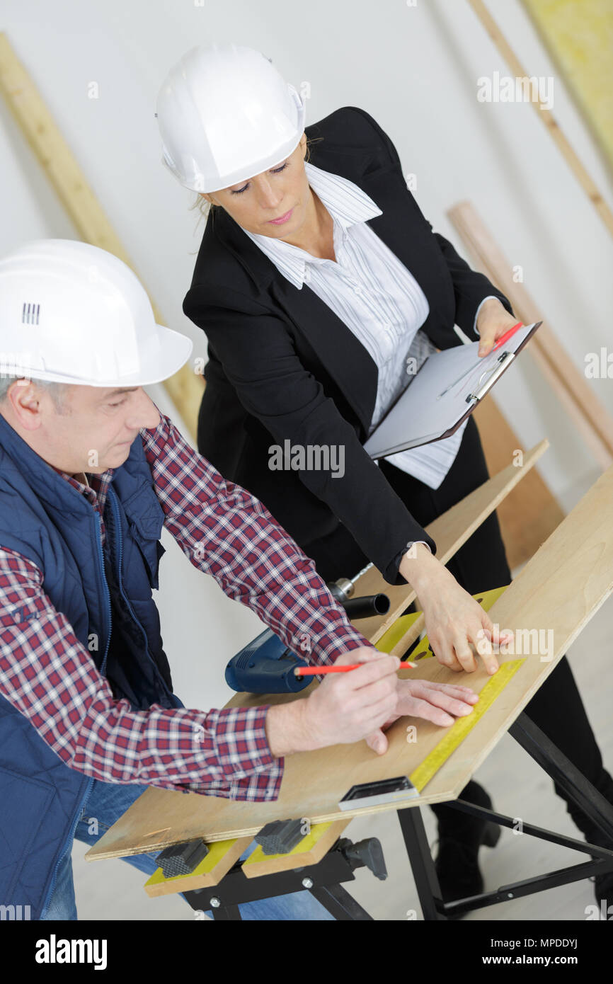 female architect and carpenter at construction site Stock Photo - Alamy